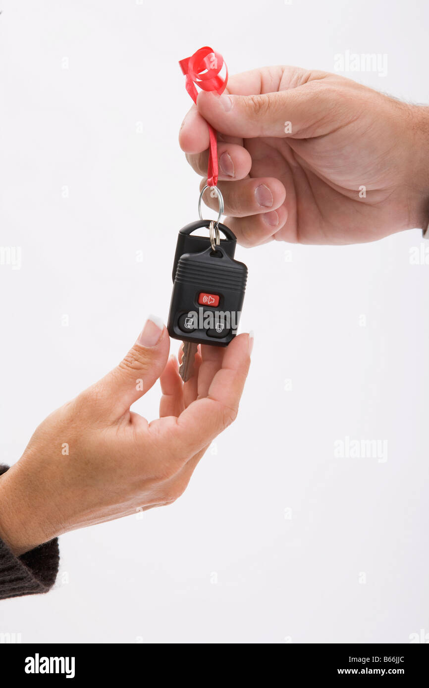 Man giving car keys to woman, close-up Stock Photo - Alamy