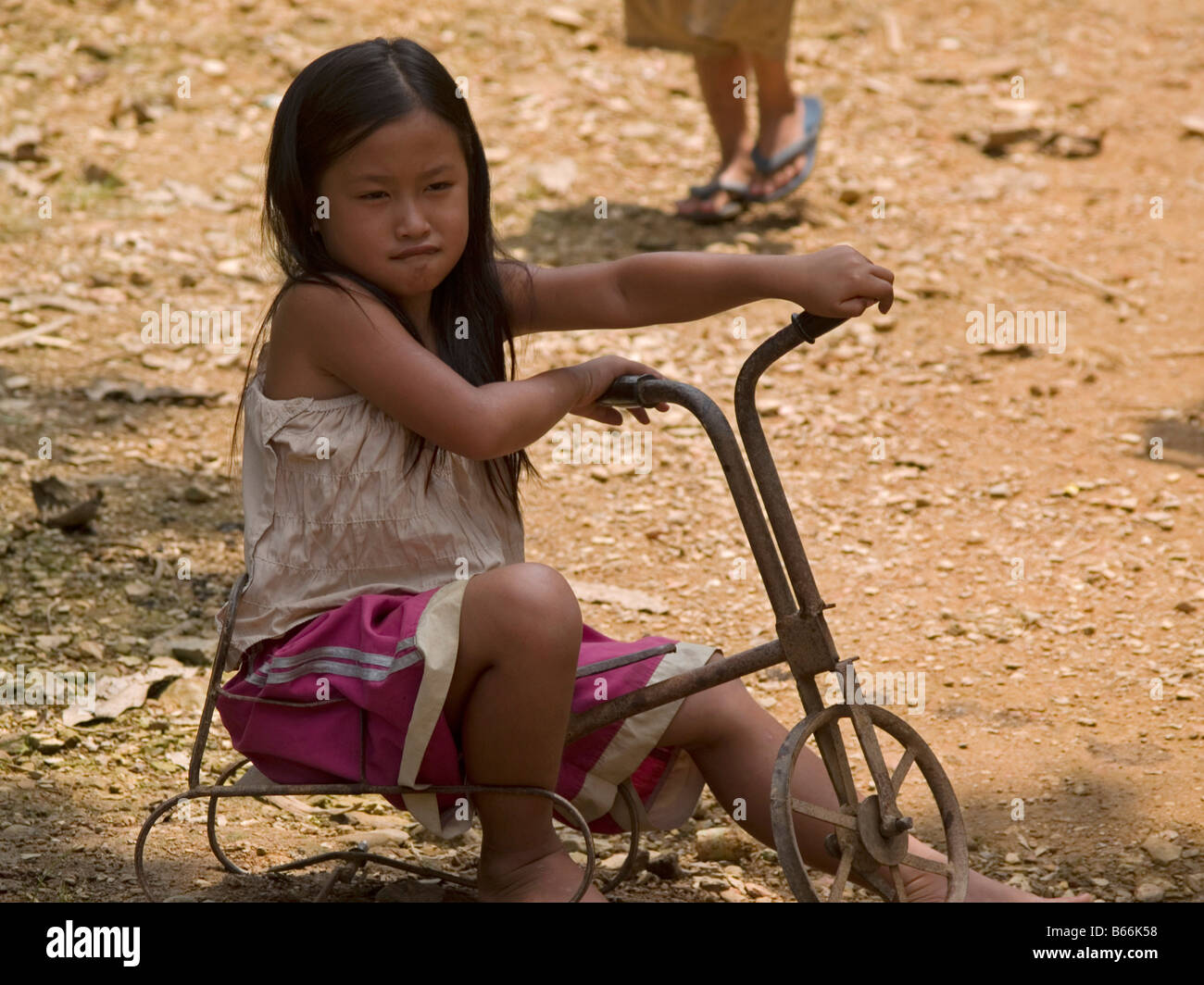 girl at play in Muang Ngoi village in northern Laos Stock Photo - Alamy