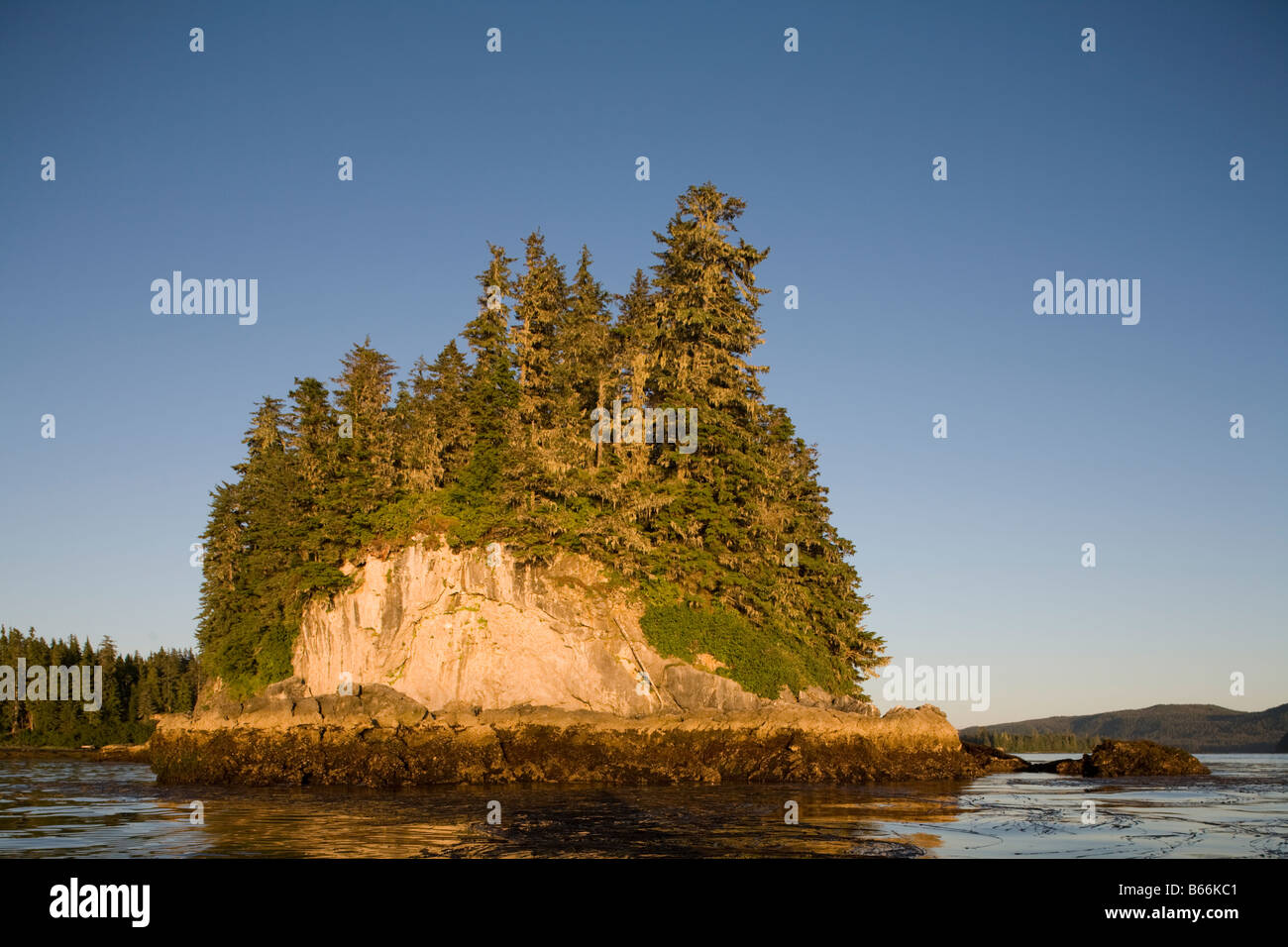 USA Alaska Setting sun lights islands along Frederick Sound Stock Photo ...