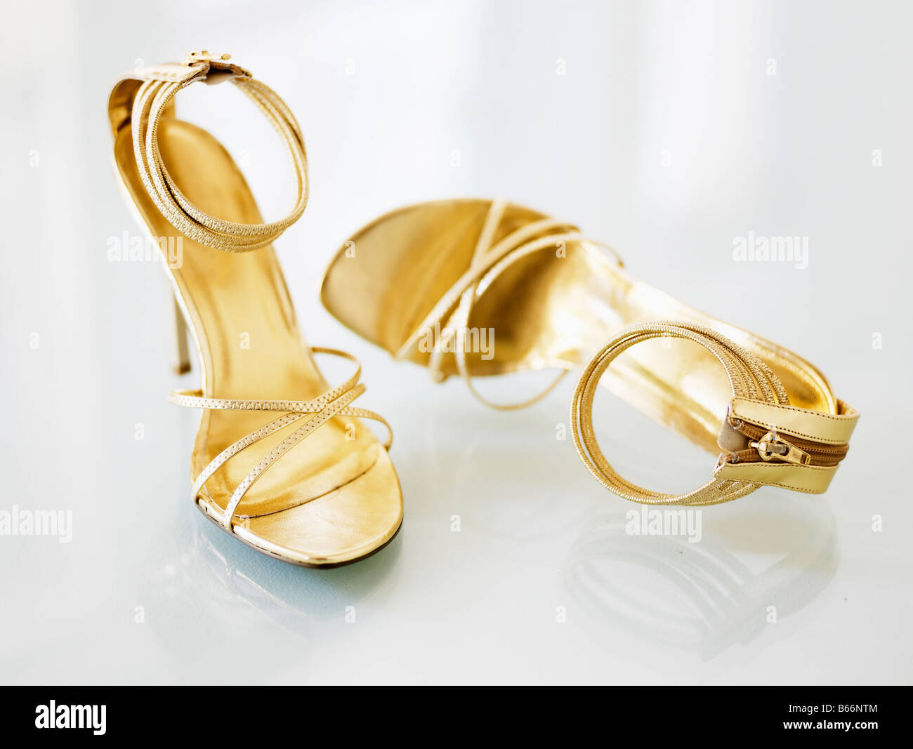 Pair of Golden High-Heeled Shoes Stock Photo - Alamy
