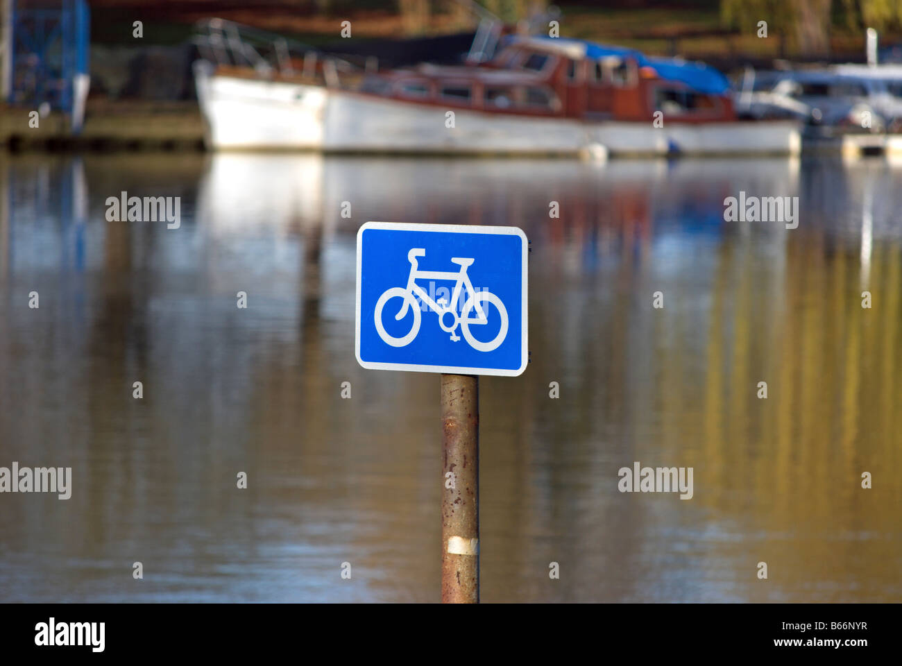 blue and white cycle path sign beside the river thames in kingston upon ...