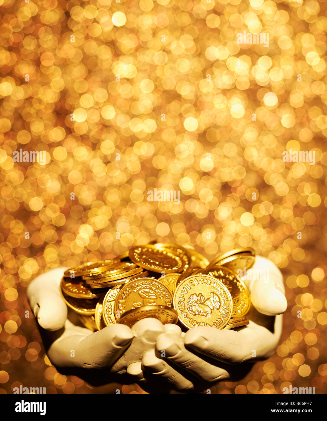 Gold Coins on Hand Sculpture Stock Photo - Alamy