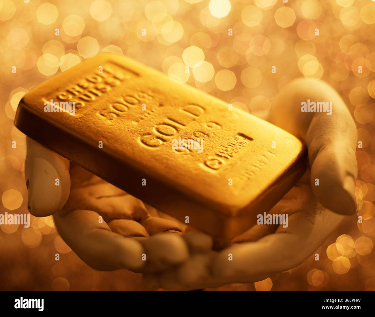 Gold Bar on Hand Sculpture Stock Photo - Alamy