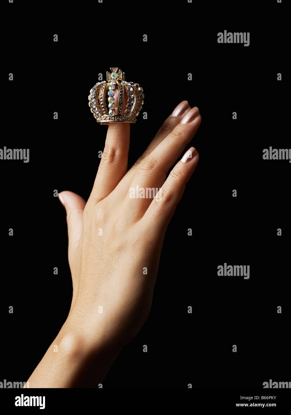 Miniature Crown on Woman's Finger Stock Photo - Alamy