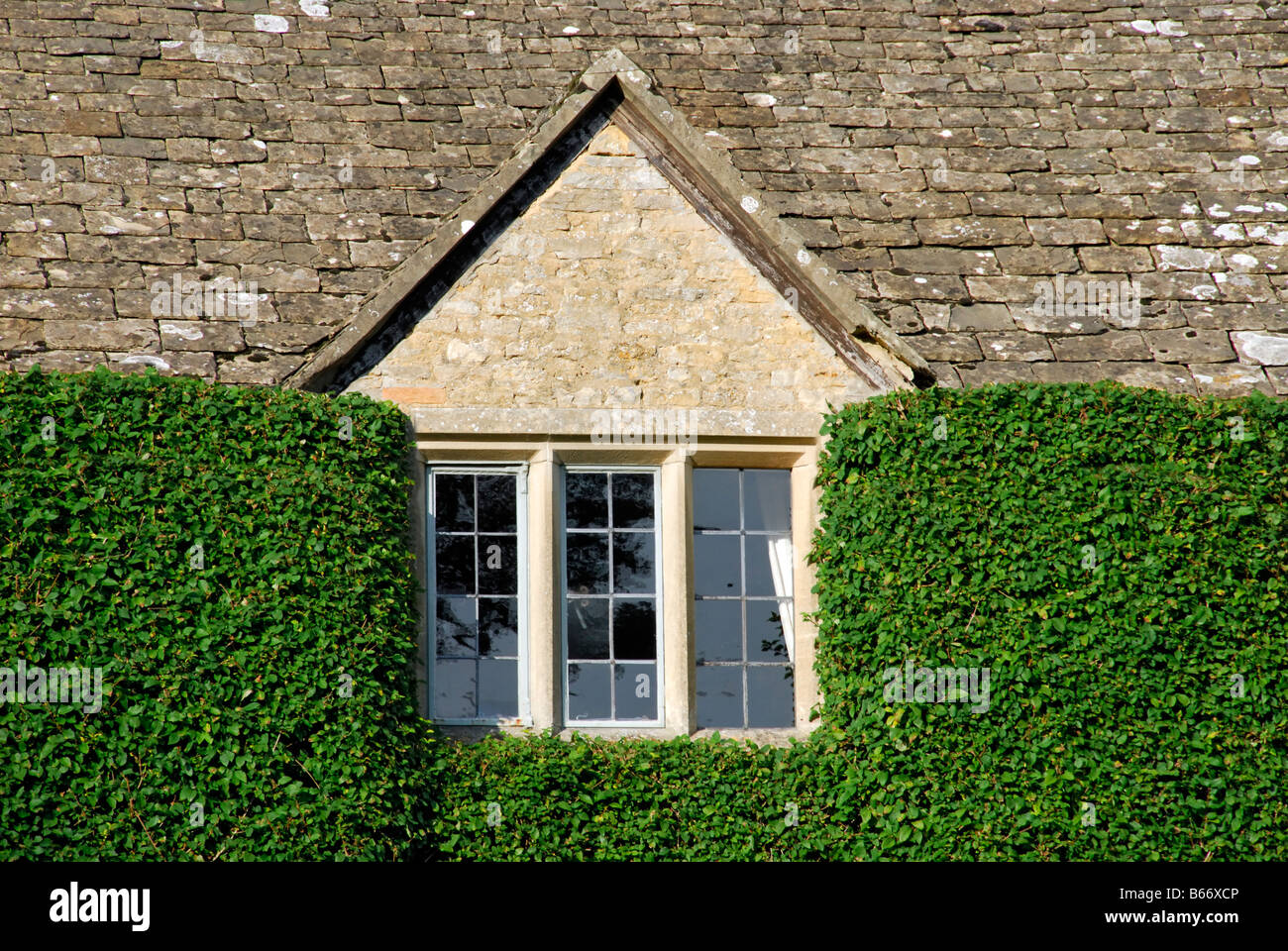 window in limestone tiled roof Stock Photo - Alamy