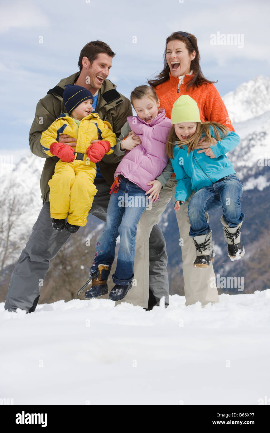 Family having fun in the snow Stock Photo - Alamy