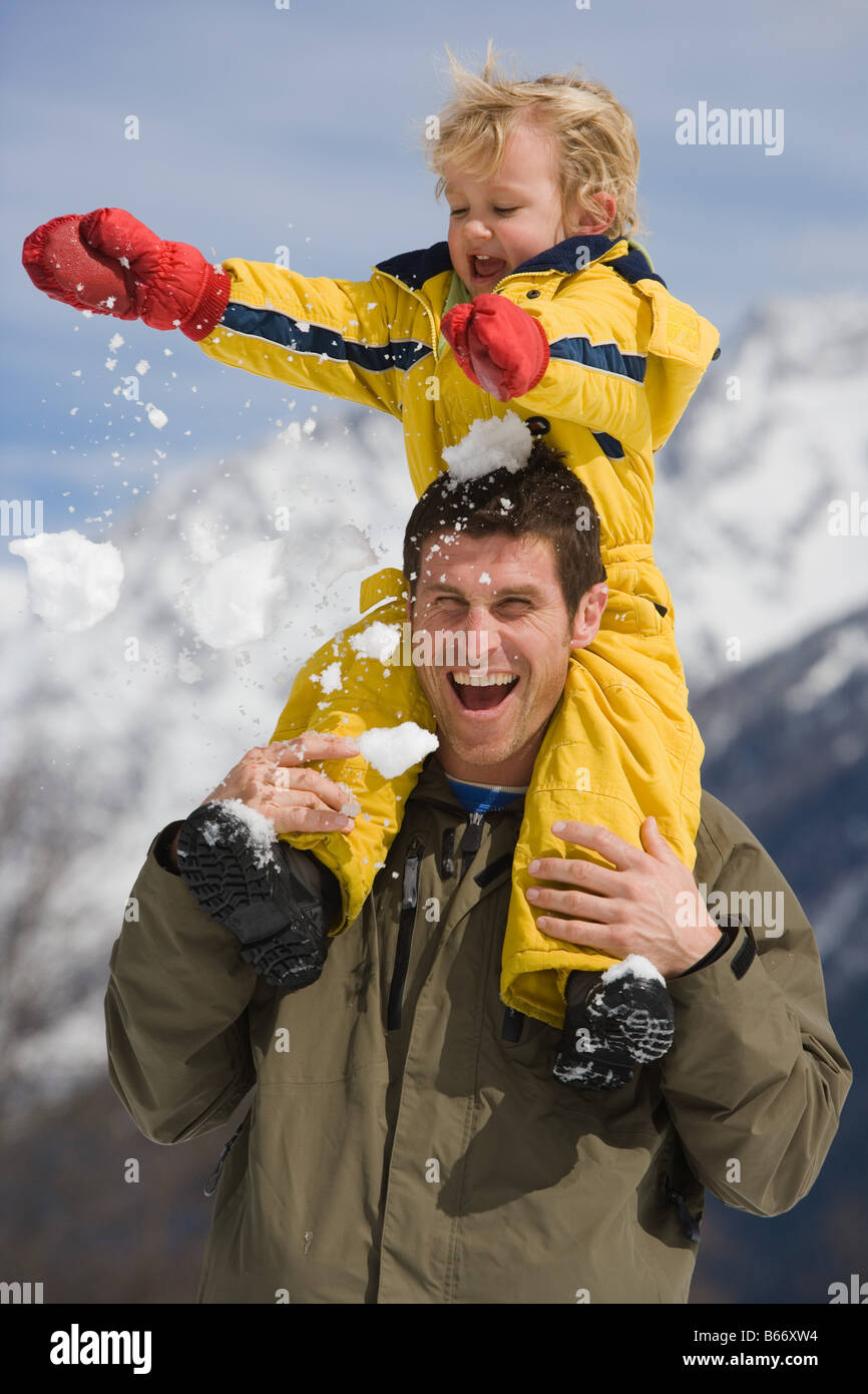Boy on fathers shoulders Stock Photo - Alamy