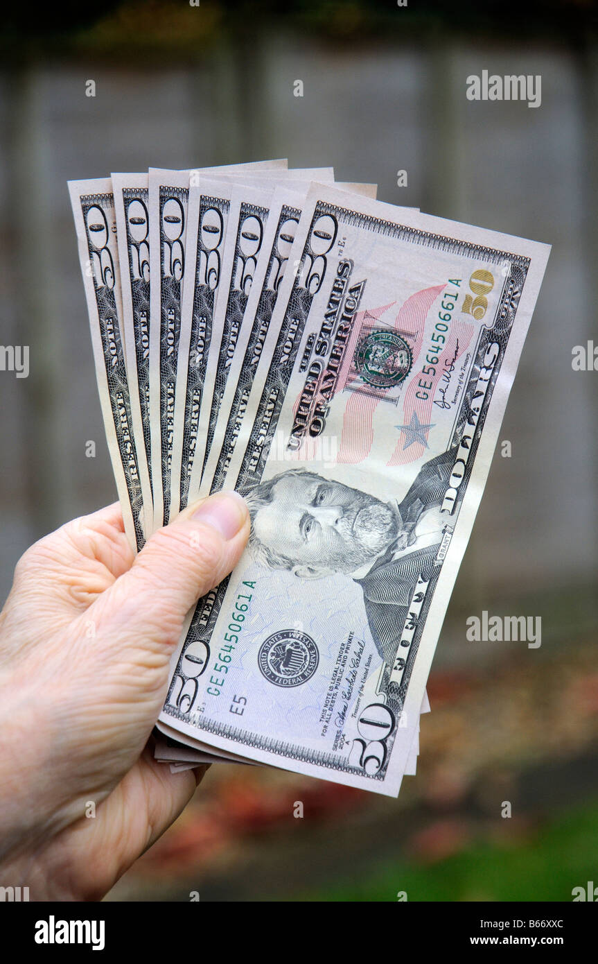 Hand holding 50 fifty US dollar bills notes Stock Photo - Alamy