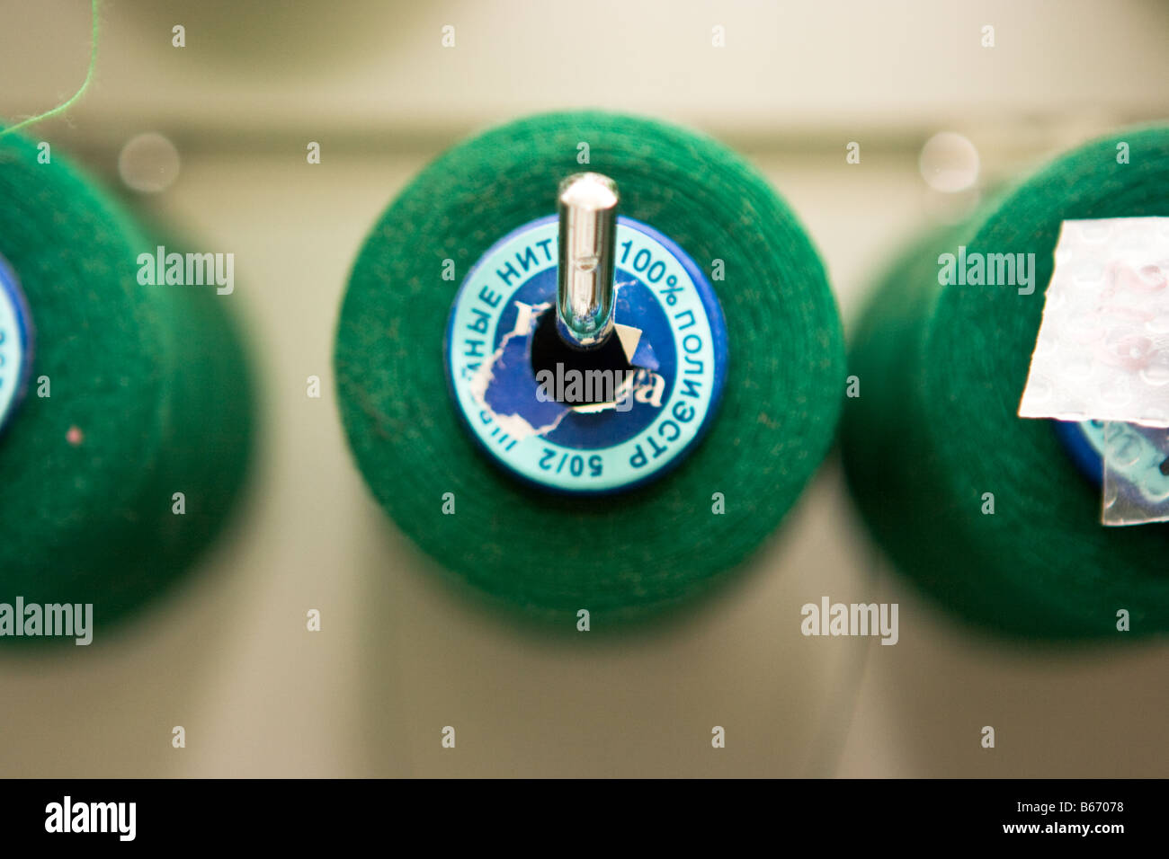 Bobbins of threads hanging on the wall Stock Photo - Alamy