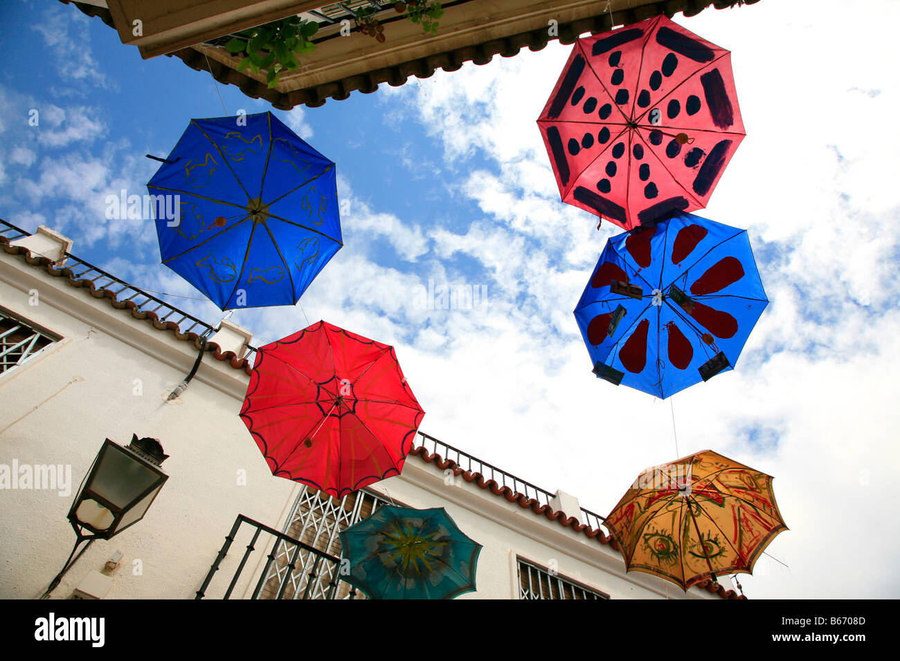 Art installation of umbrellas by local residents in a street in Cordoba ...