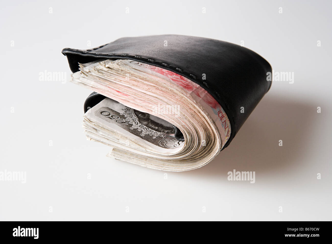 Wallet filled with banknotes Stock Photo - Alamy
