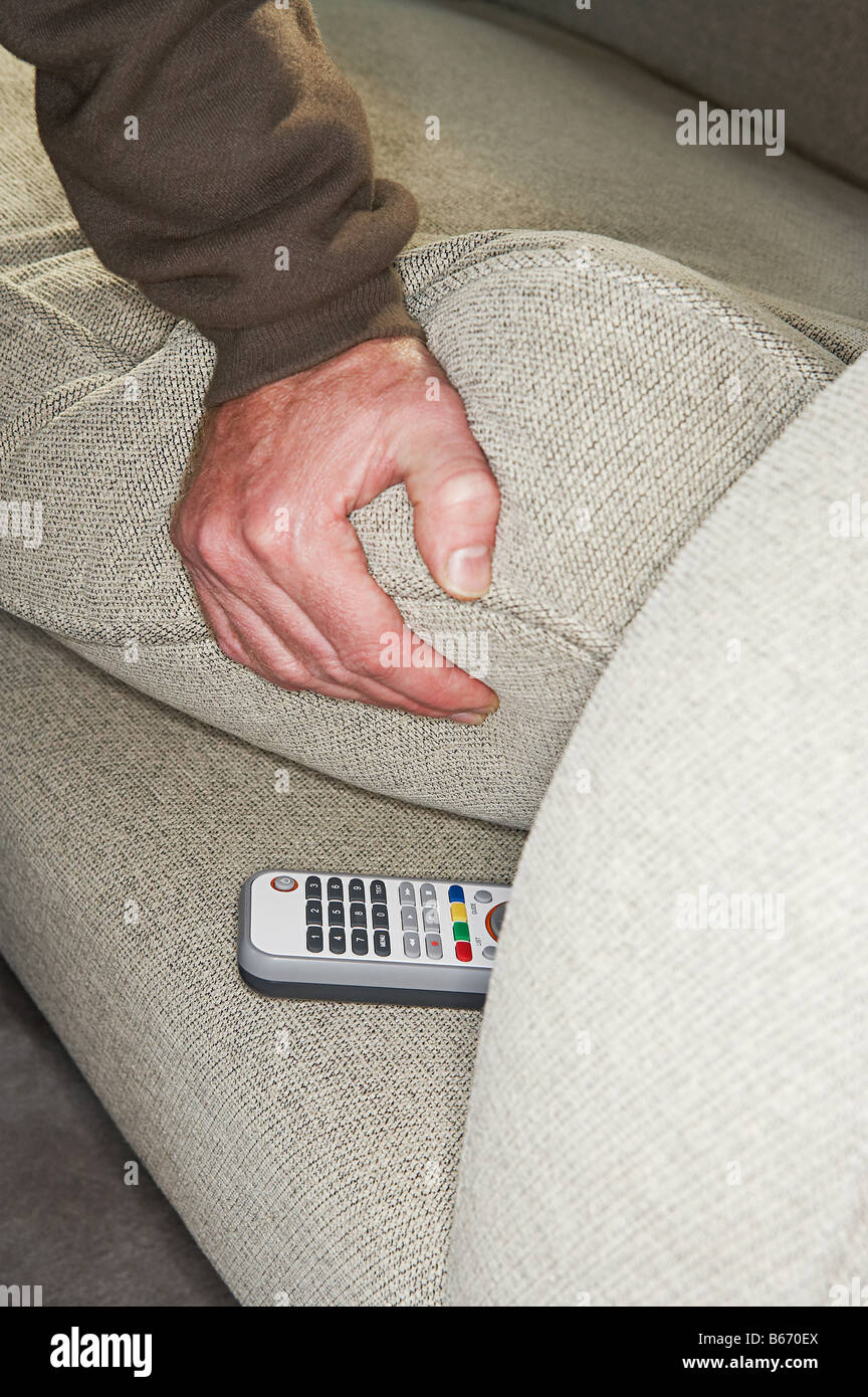 Person finding remote control Stock Photo - Alamy