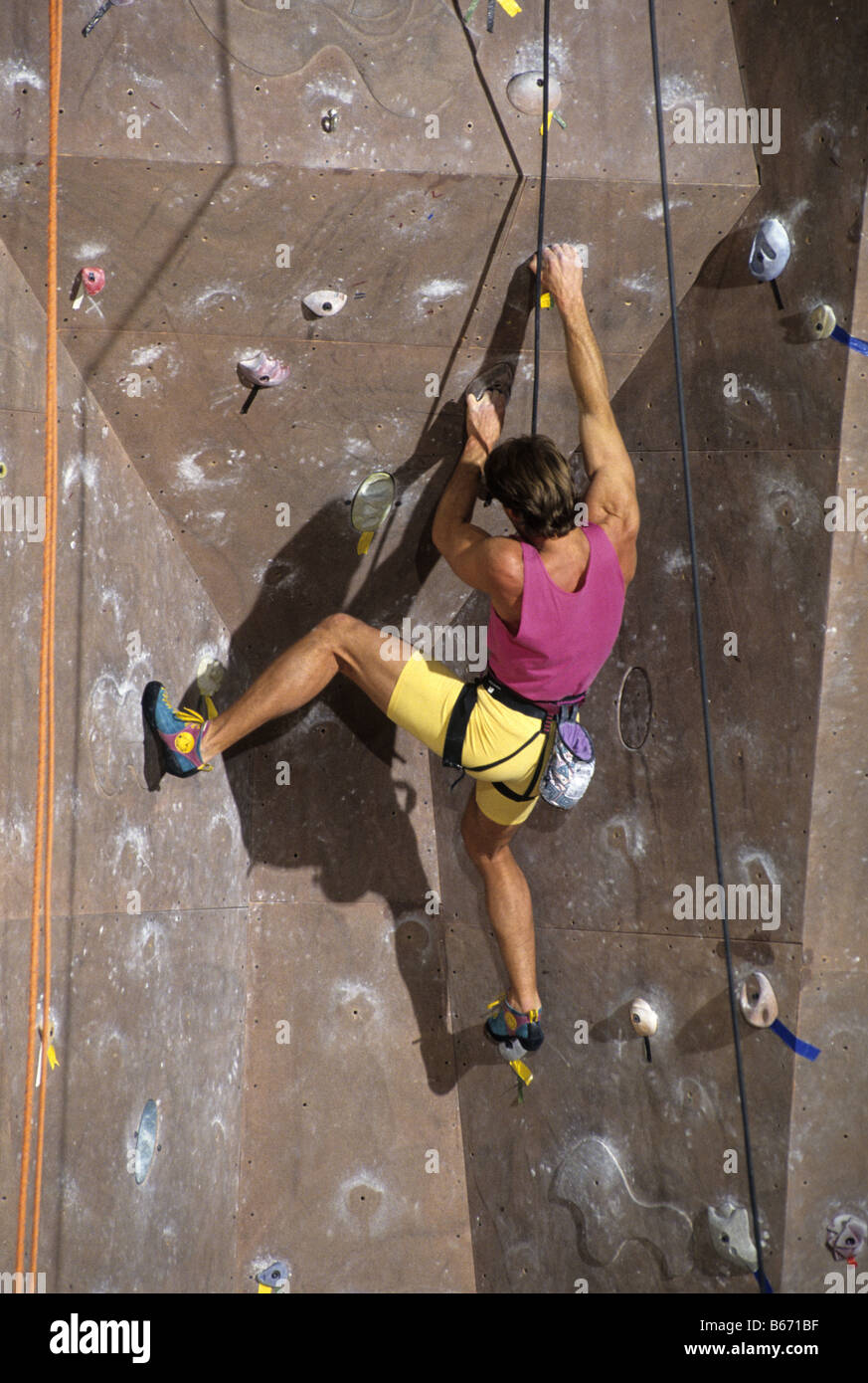 Man wall climbing indoors Stock Photo - Alamy