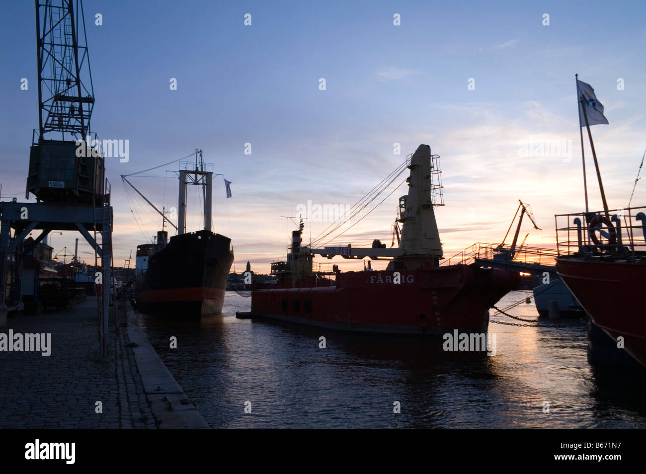 Freight ships and quayside crane at dusk on the Gota Alv (River Gota ...