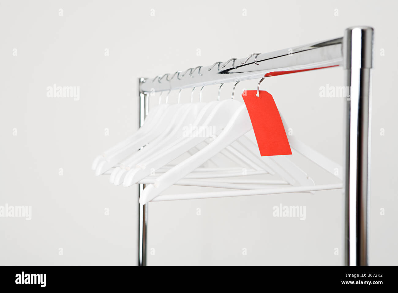 Empty clothes hangers on a rail Stock Photo - Alamy