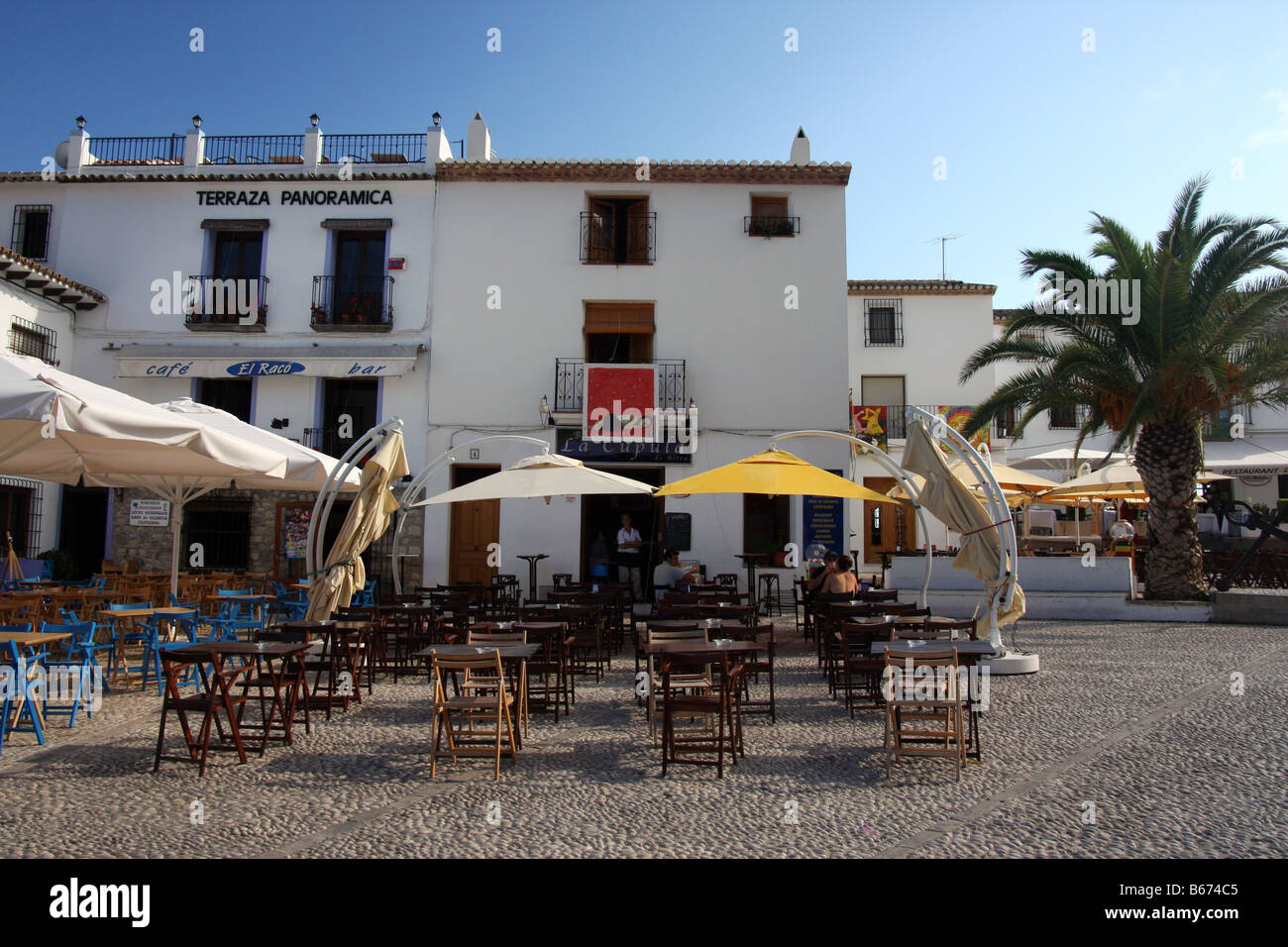 Main square in Altea, Spain, with restaurant tables set for lunch on a ...