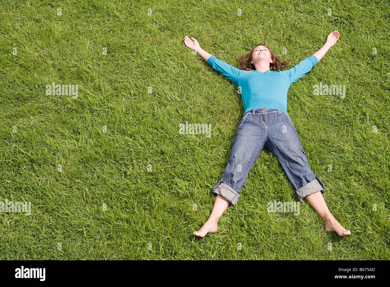 Woman lying on grass hi-res stock photography and images - Alamy