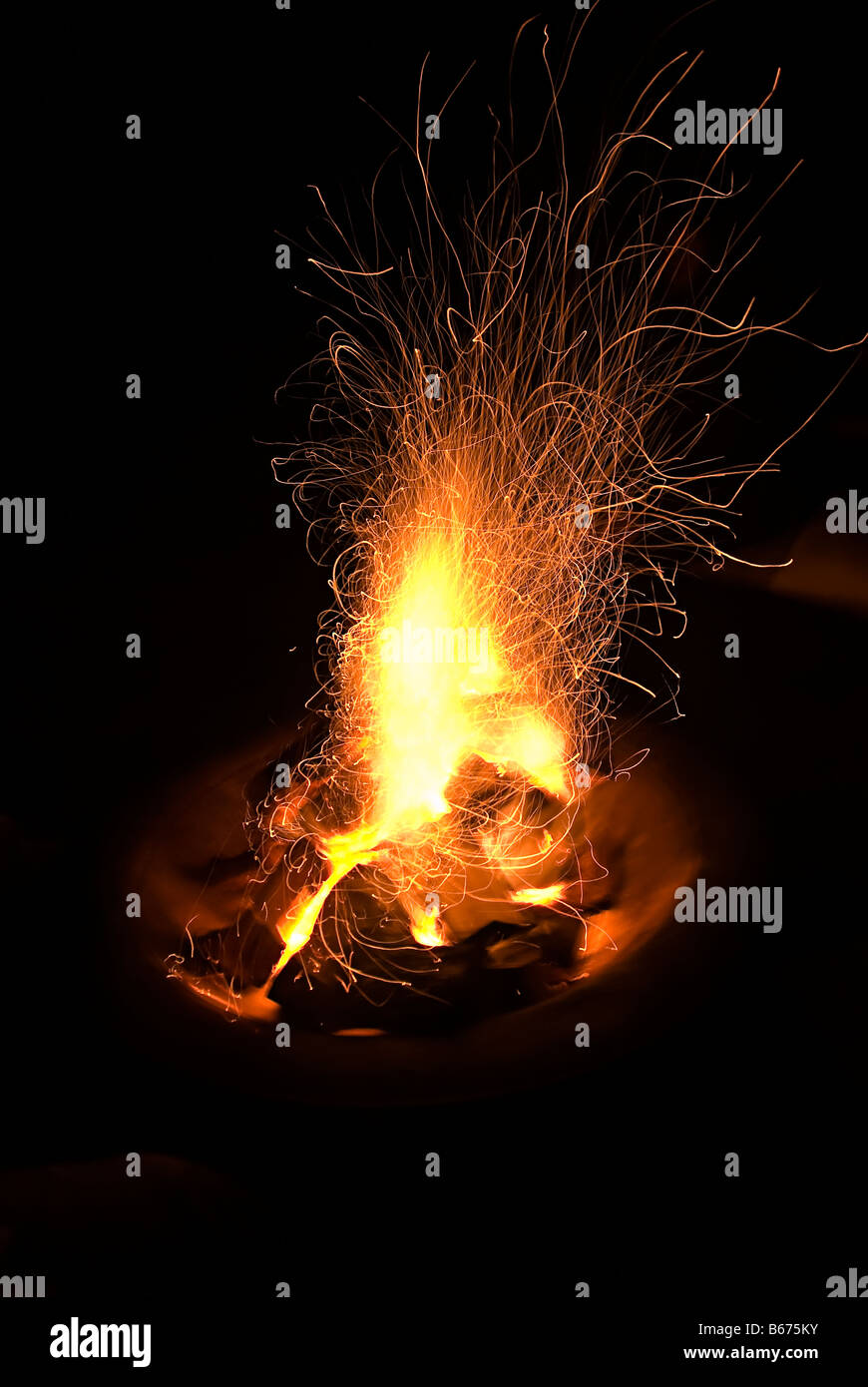 orange camp fire with sparks coming from the logs Stock Photo - Alamy