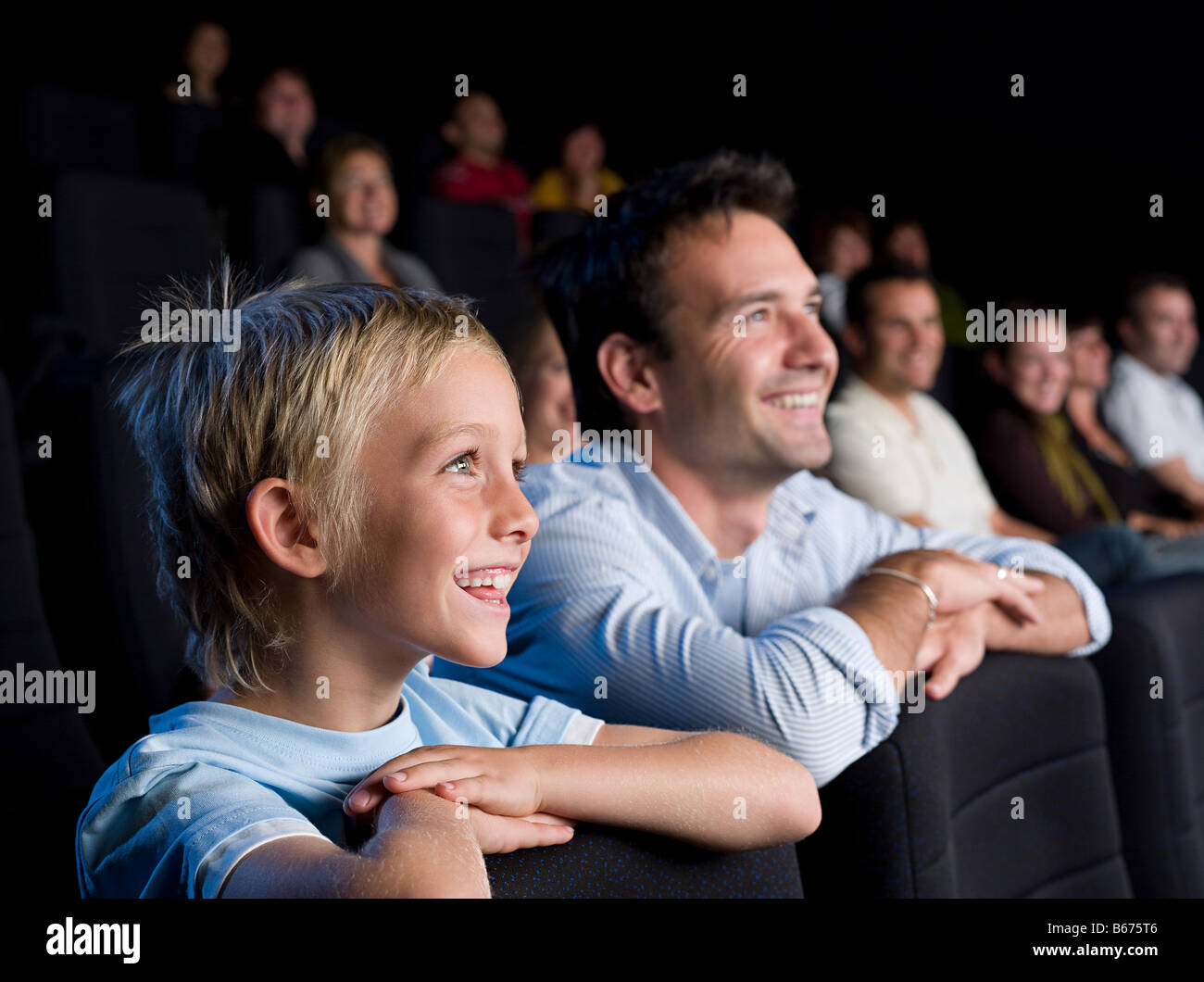 Father and son watching a movie Stock Photo - Alamy