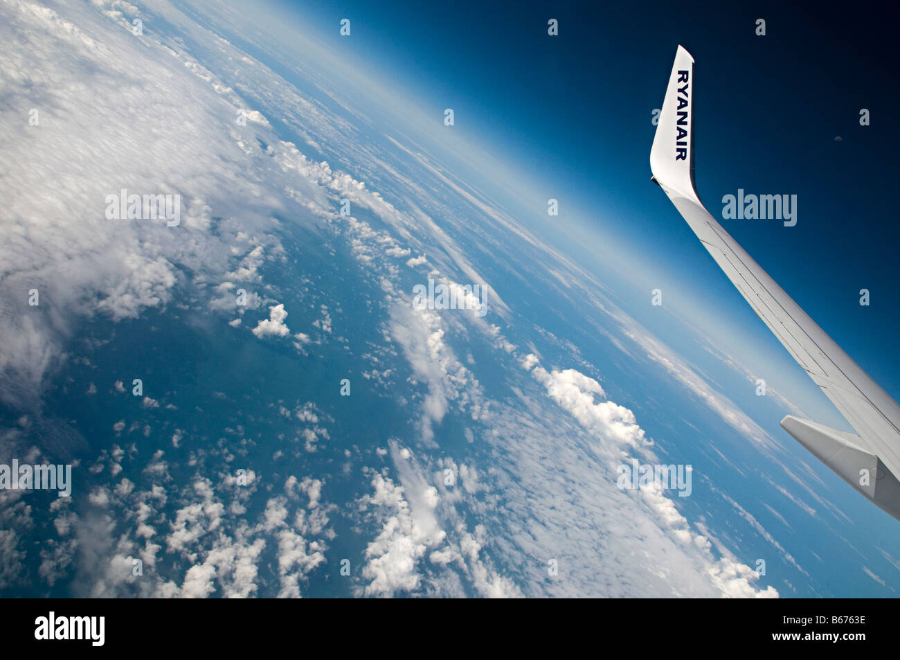 airplane wing in flight of a boeing 737 800 of a Ryanair plane ay high ...