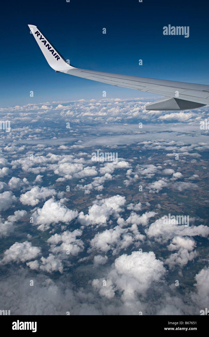 airplane wing in flight of a boeing 737 800 of a Ryanair plane with ...