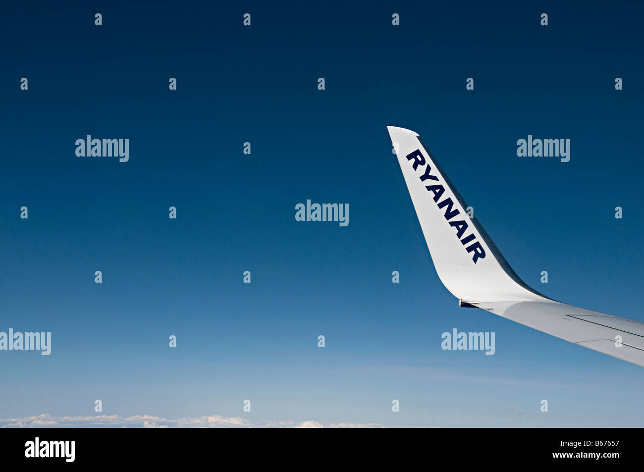 airplane wing in flight of a boeing 737 800 of a Ryanair plane with a ...