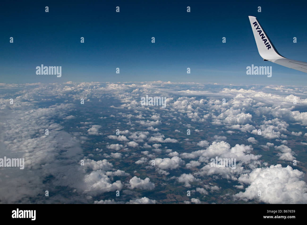 airplane wing in flight of a boeing 737 800 of a Ryanair plane with ...