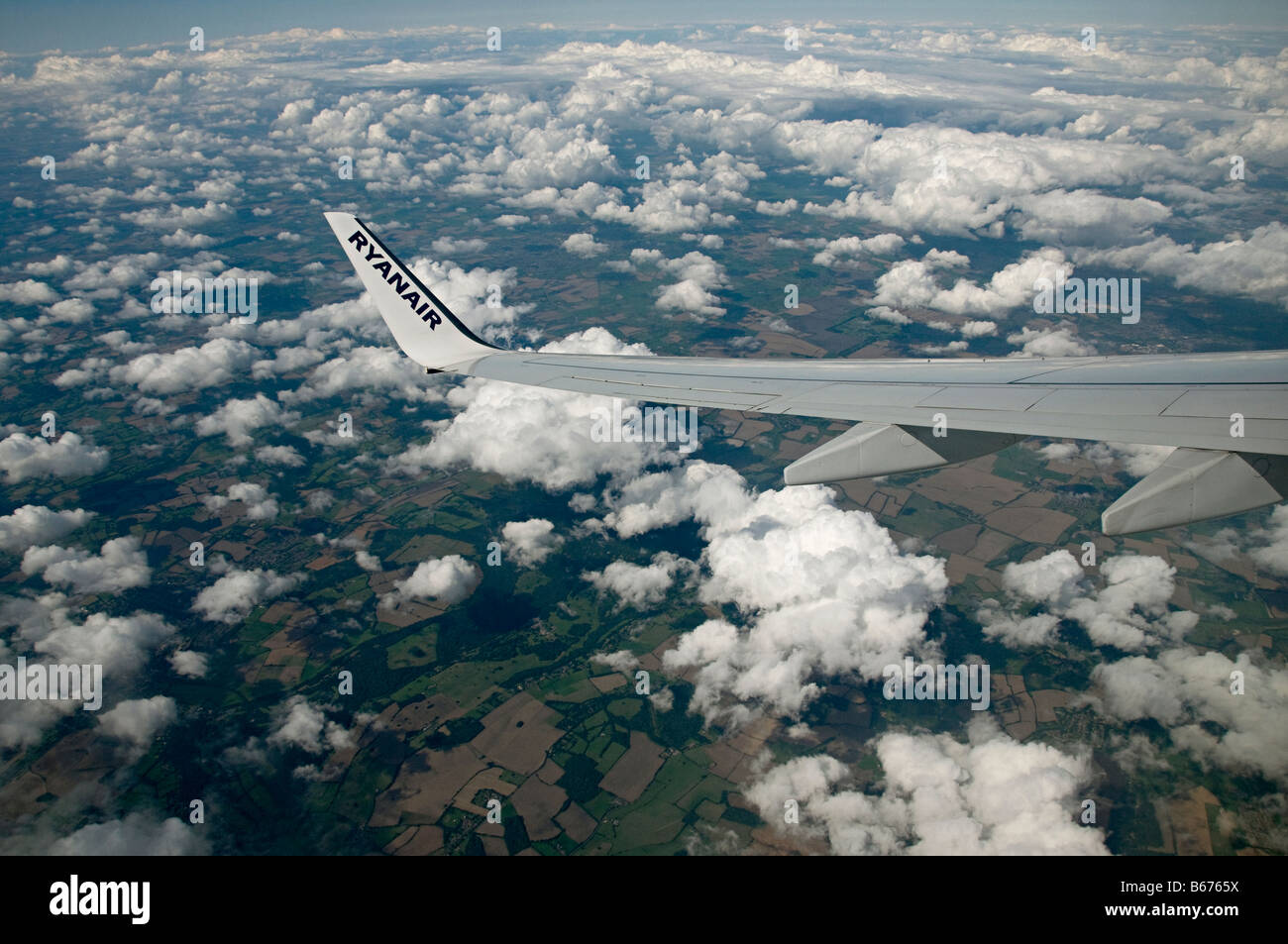 airplane wing in flight of a boeing 737 800 of a Ryanair plane with ...