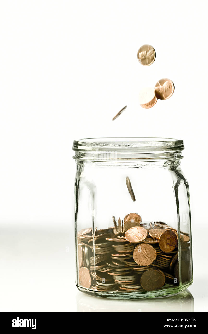 Coins in a jar Stock Photo - Alamy