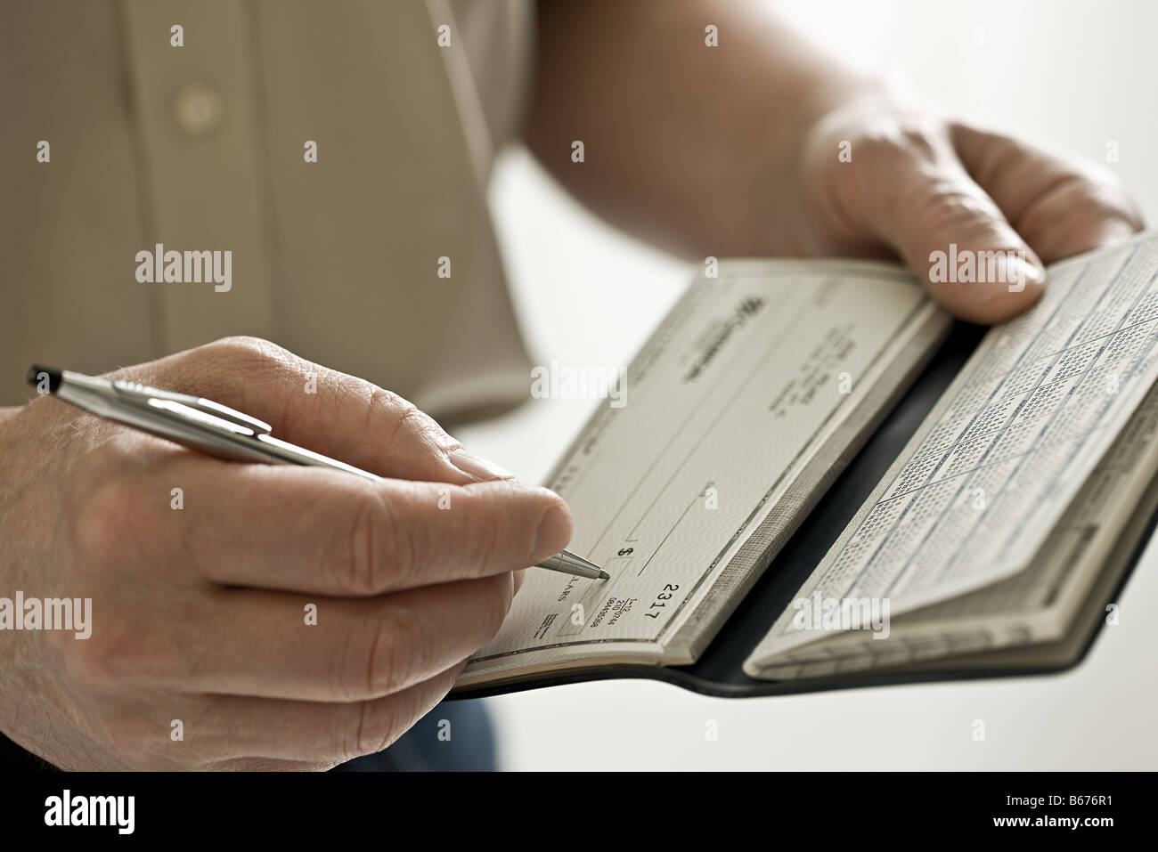 A man holding a cheque book Stock Photo - Alamy