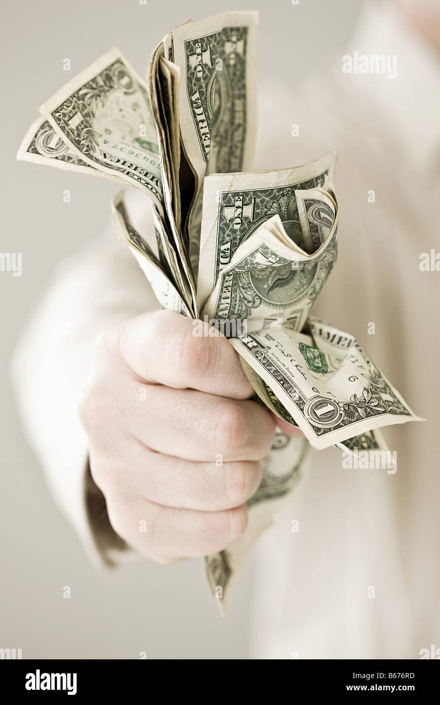 A person holding a bunch of dollars Stock Photo - Alamy