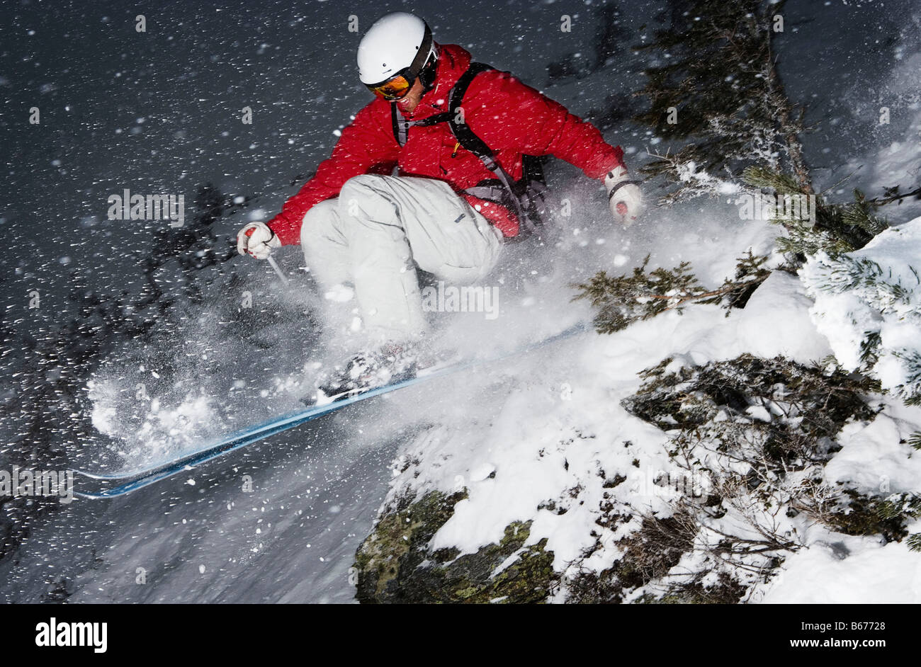 Skier jumping over small rock Stock Photo - Alamy