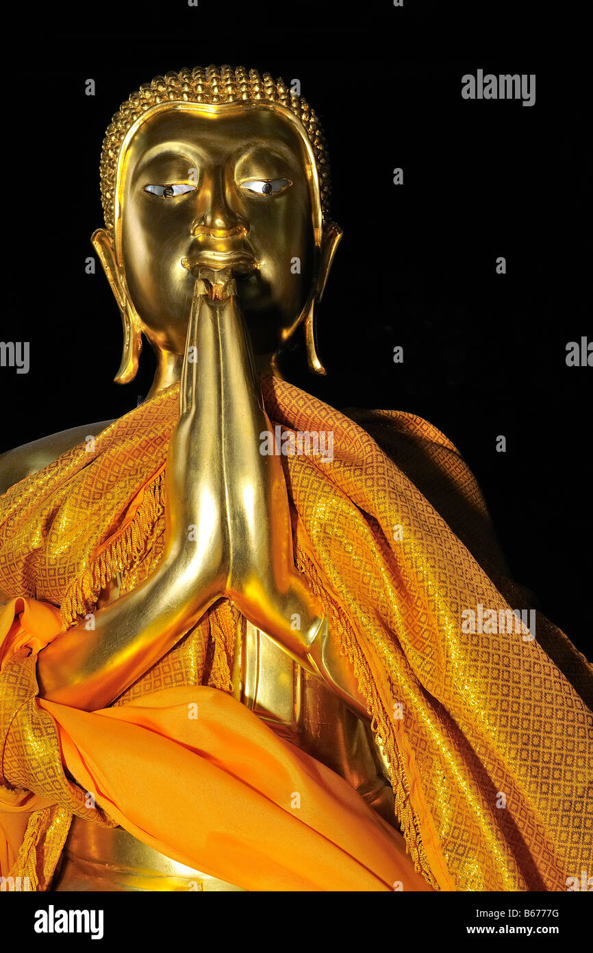 Gilded statue of a Buddha disciple in Buddhist temple in Bangkoks ...