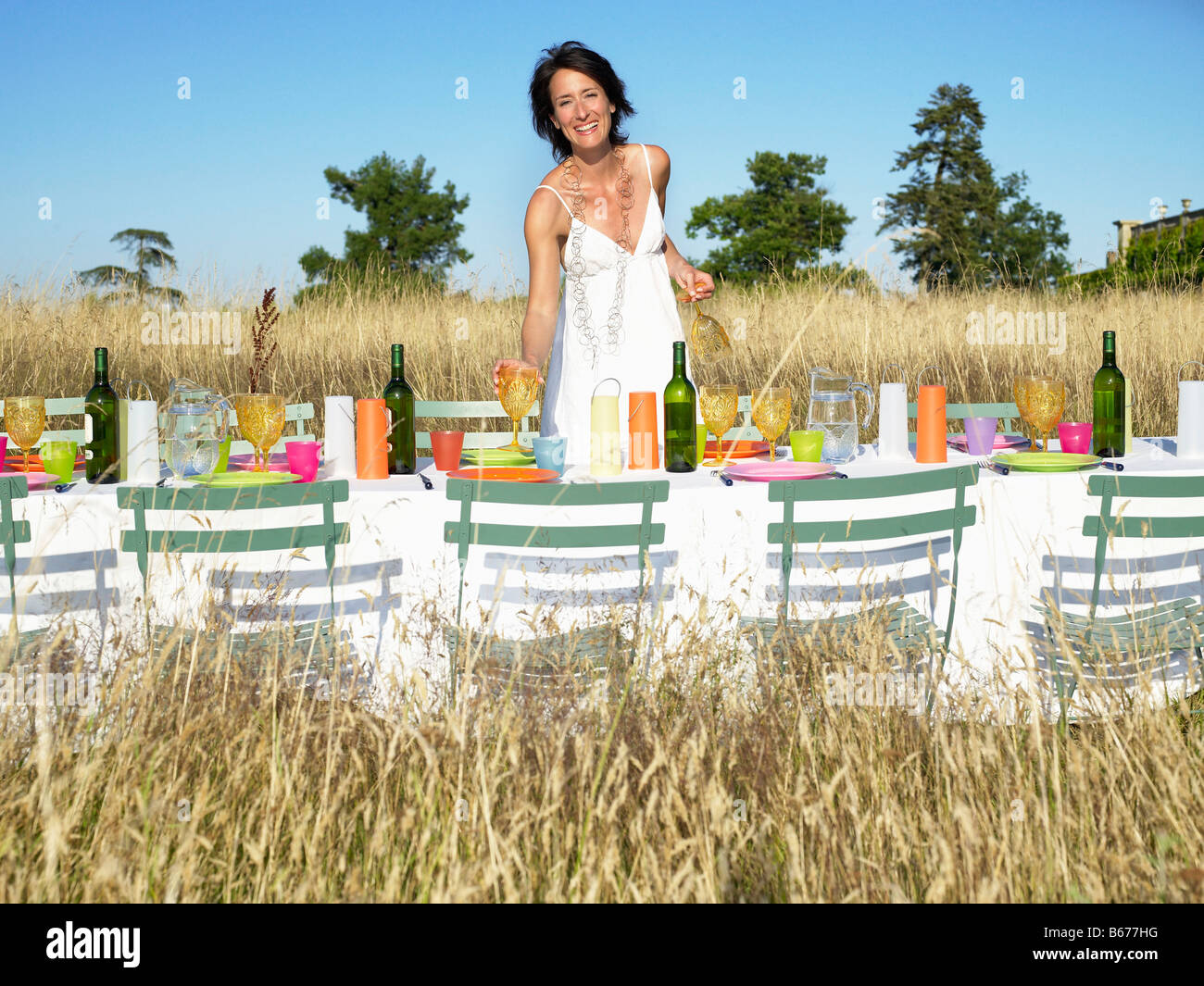 Woman standing next to a table, outdoors Stock Photo - Alamy
