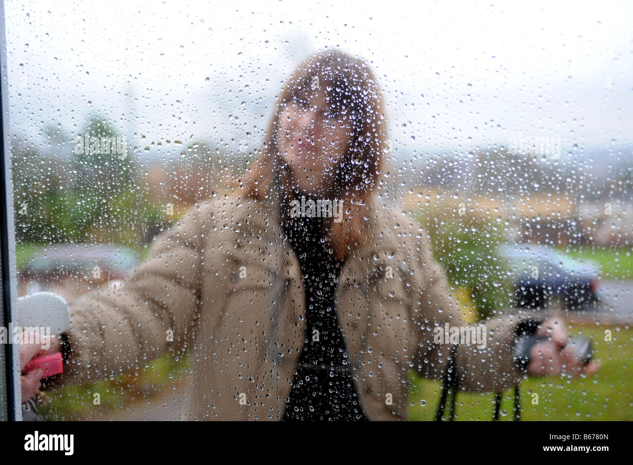 Rainy day in England, Britain with woman opening her front door Stock ...