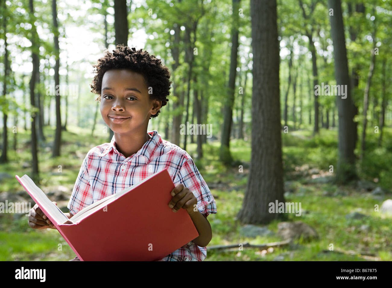 A boy holding a book Stock Photo - Alamy