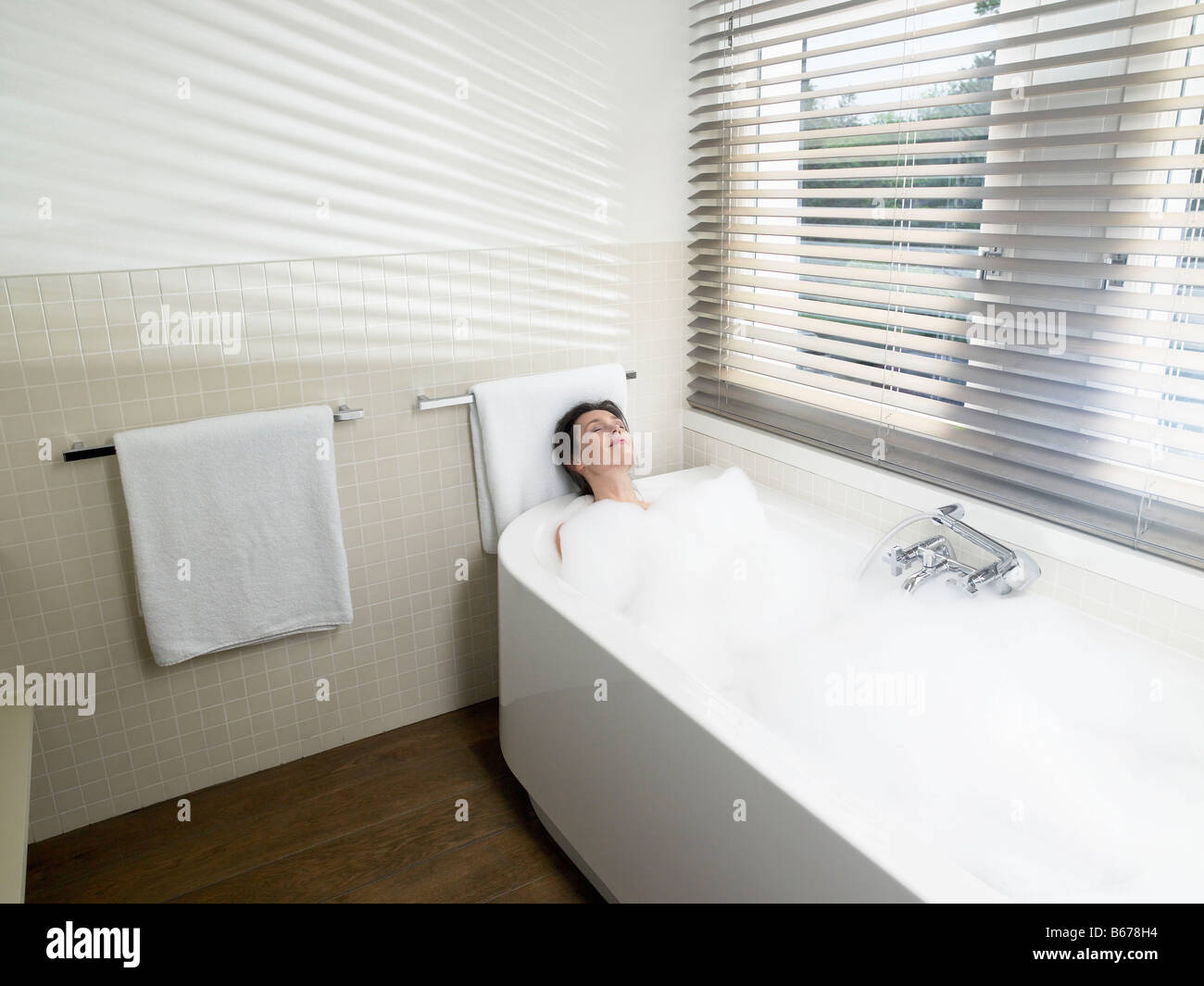 Mid adult woman taking bath hi-res stock photography and images - Alamy