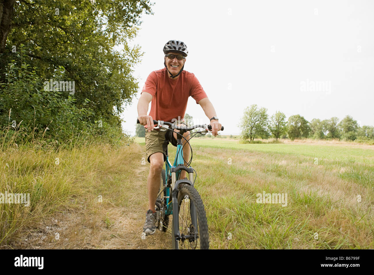 Healthy man riding bicycle hi-res stock photography and images - Alamy