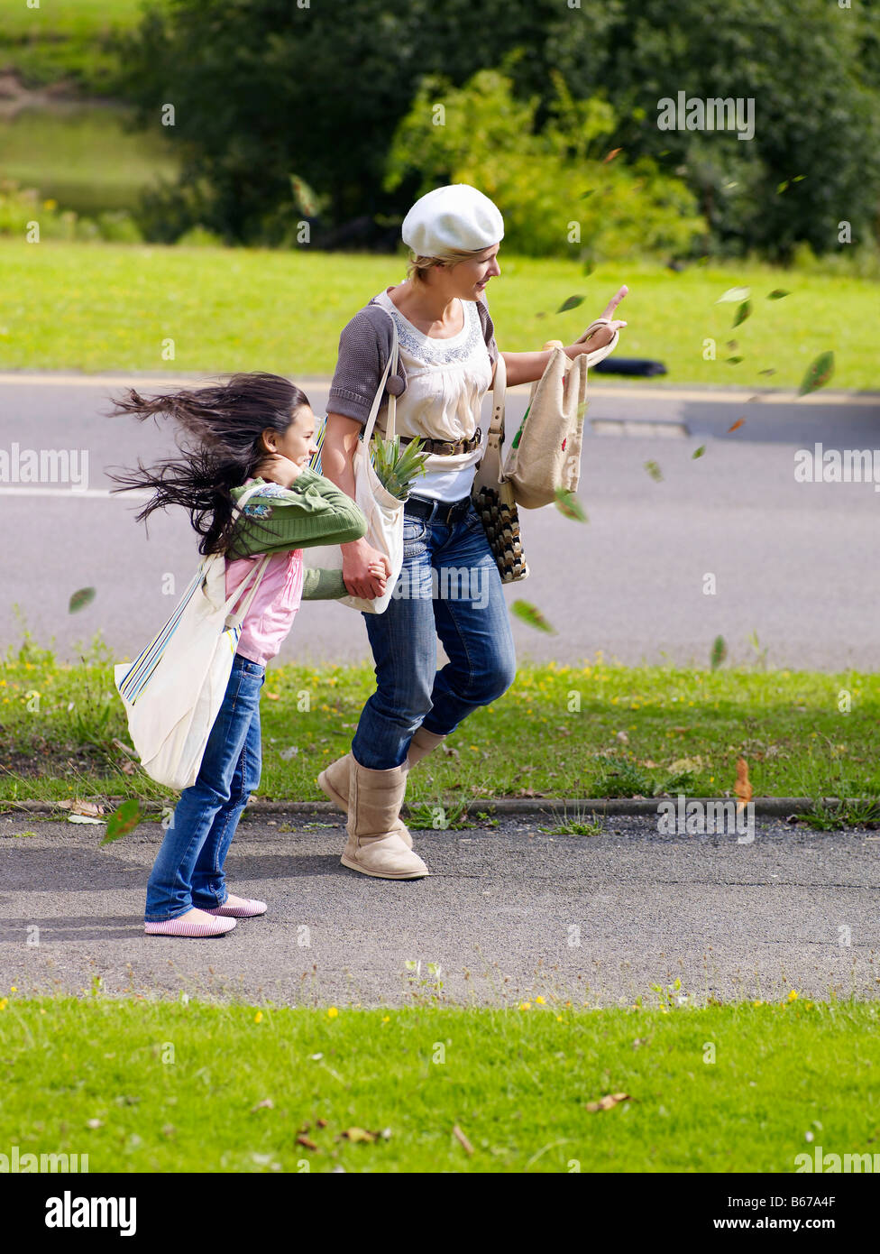 Mother and daughter walking in wind Stock Photo - Alamy