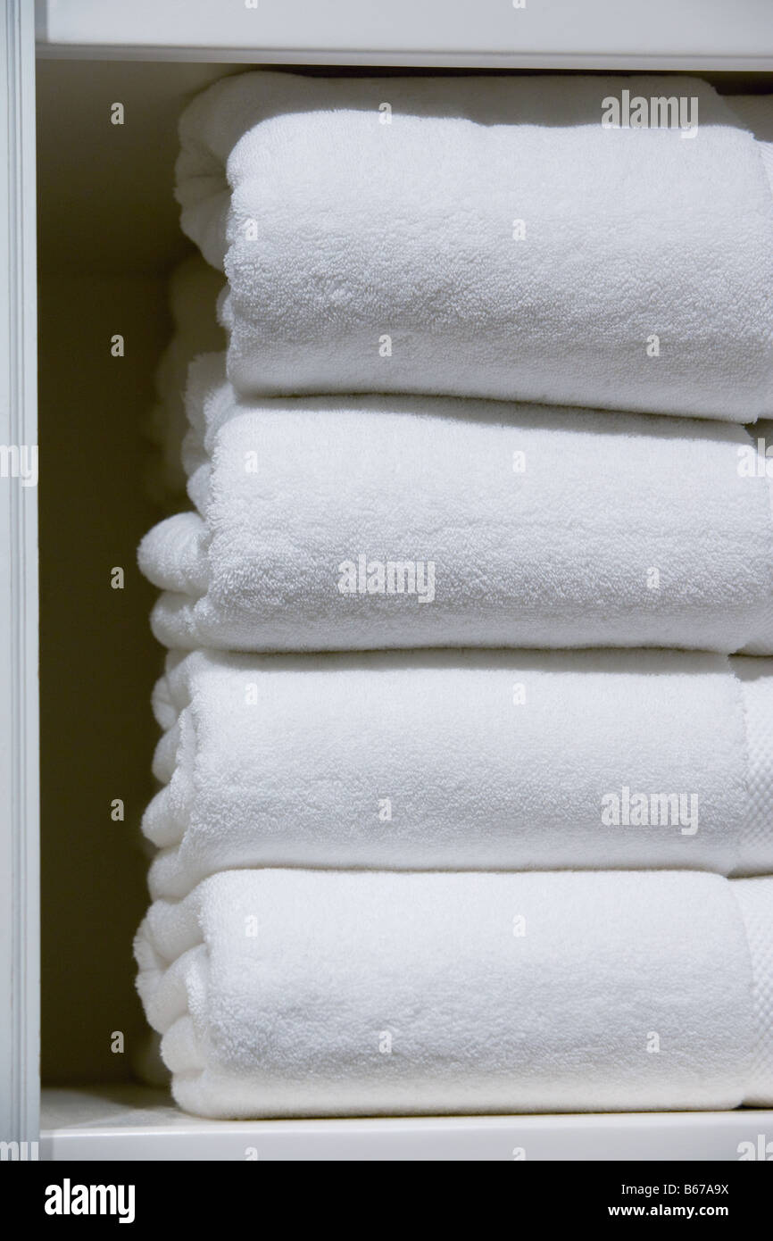 Stacks of fresh white towels on a shelf Stock Photo - Alamy