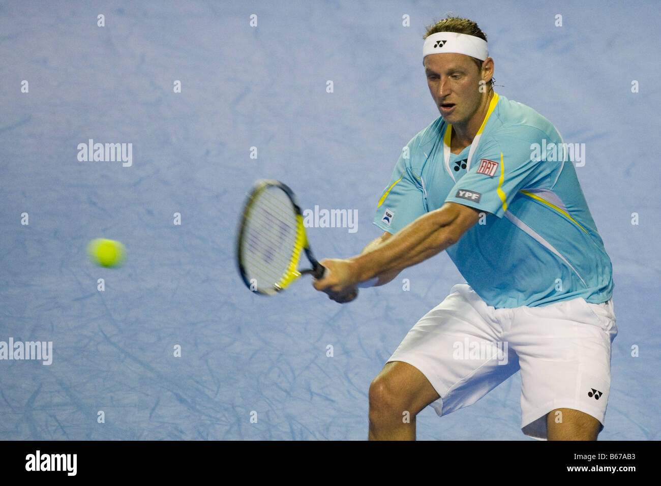 Argentinian tennis player David Nalbandian hitting a backhand shot ...