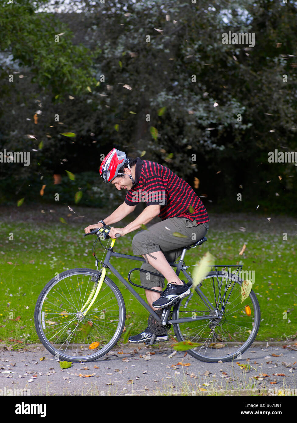 Man cycling in wind Stock Photo - Alamy