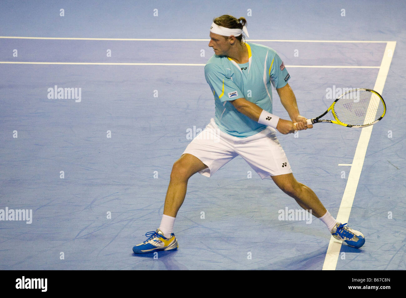 Argentinian tennis player David Nalbandian hitting a backhand shot ...