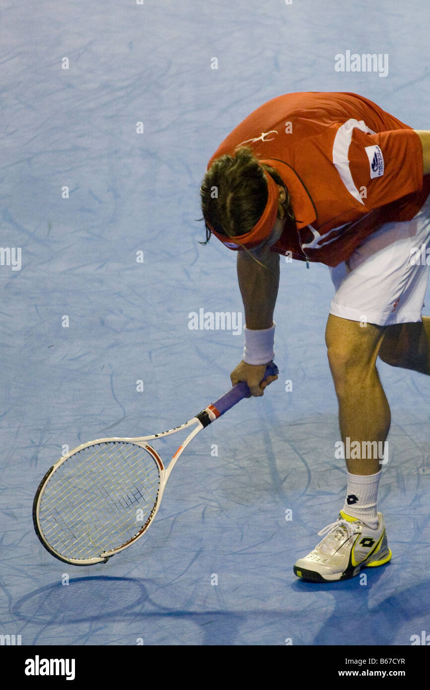 Spanish tennis player David Ferrer hitting and breakinf his racket ...