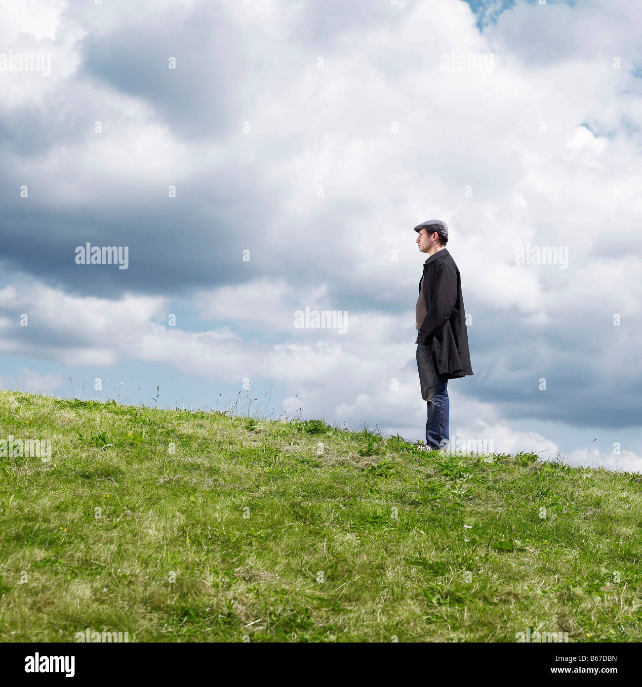 Lone man standing on hill Stock Photo - Alamy