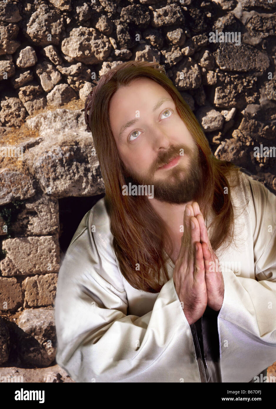 Jesus praying near brick wall Stock Photo - Alamy