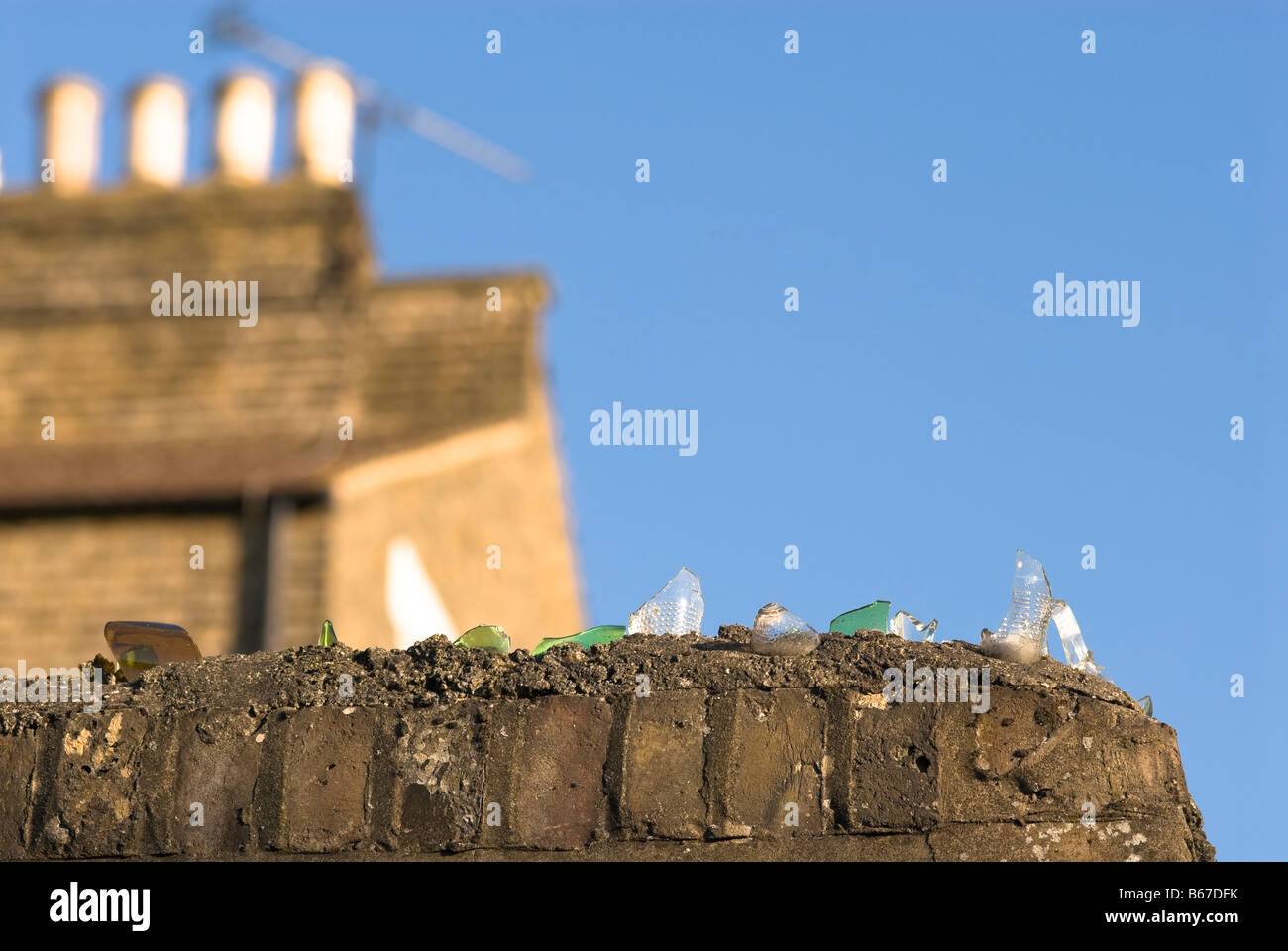 Glass shards on the boundary wall of a residential street in London ...