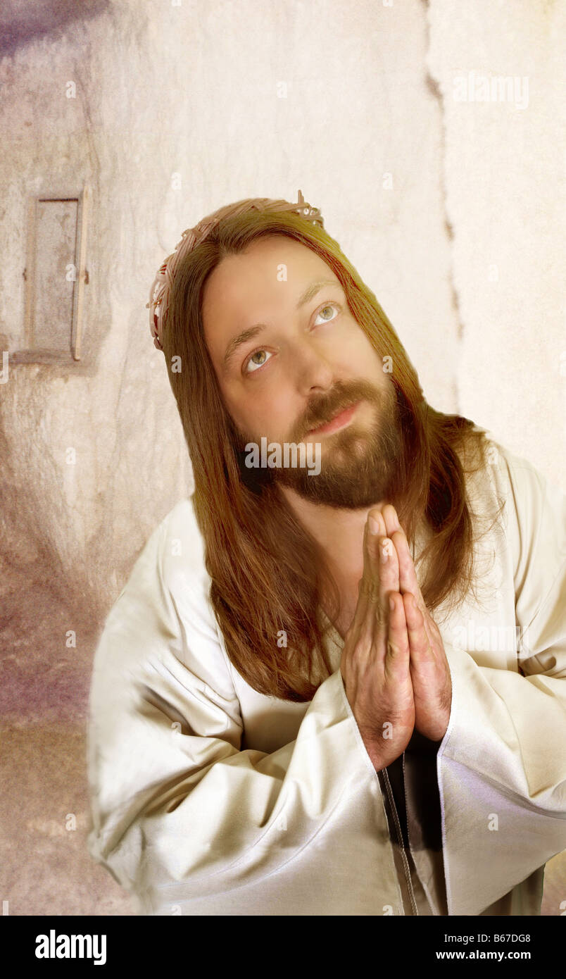 Jesus praying near ancient stone hallway Stock Photo - Alamy