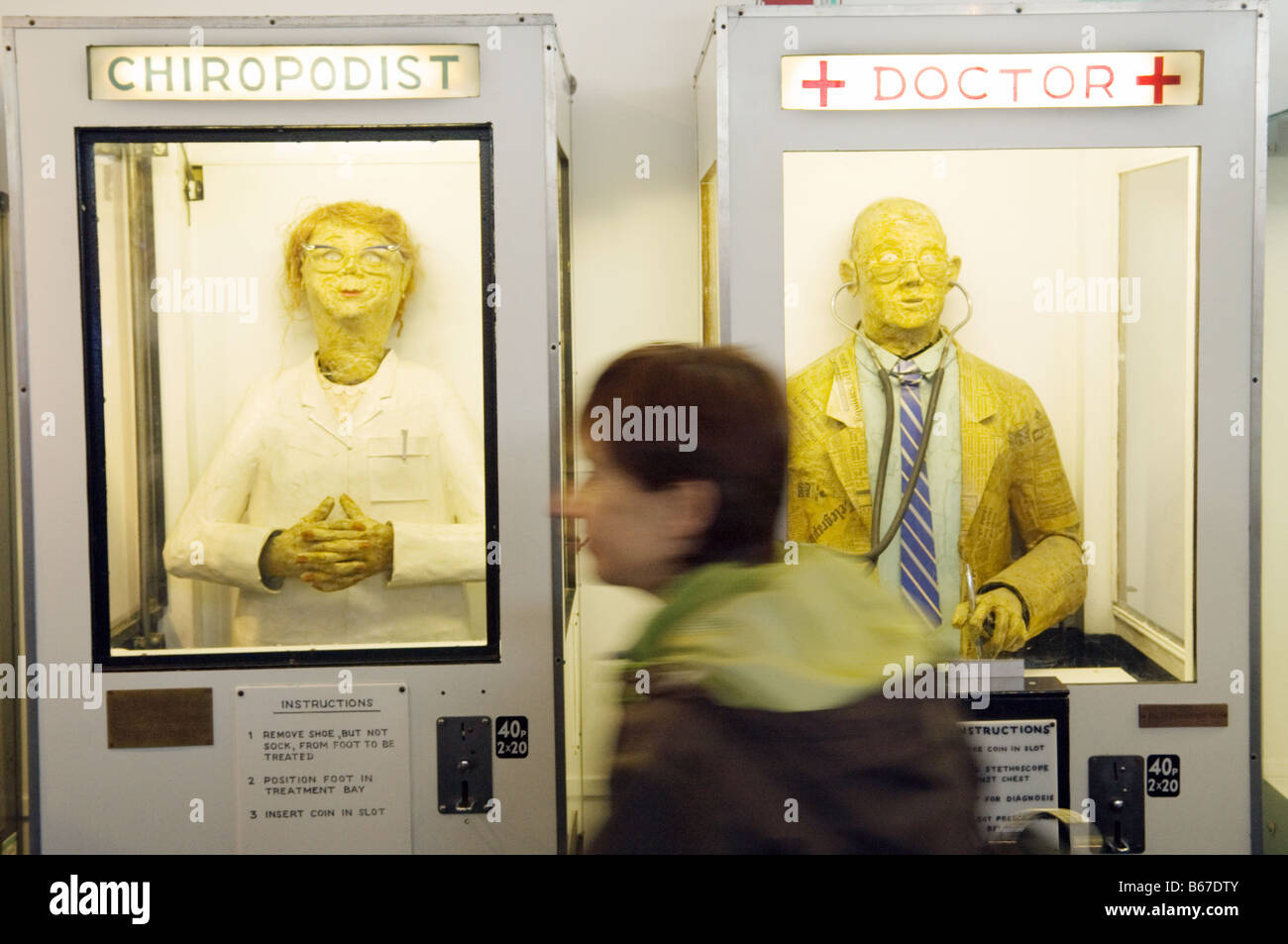 A woman walks past the "Doctor" and "Chiropodist" machines in the ...