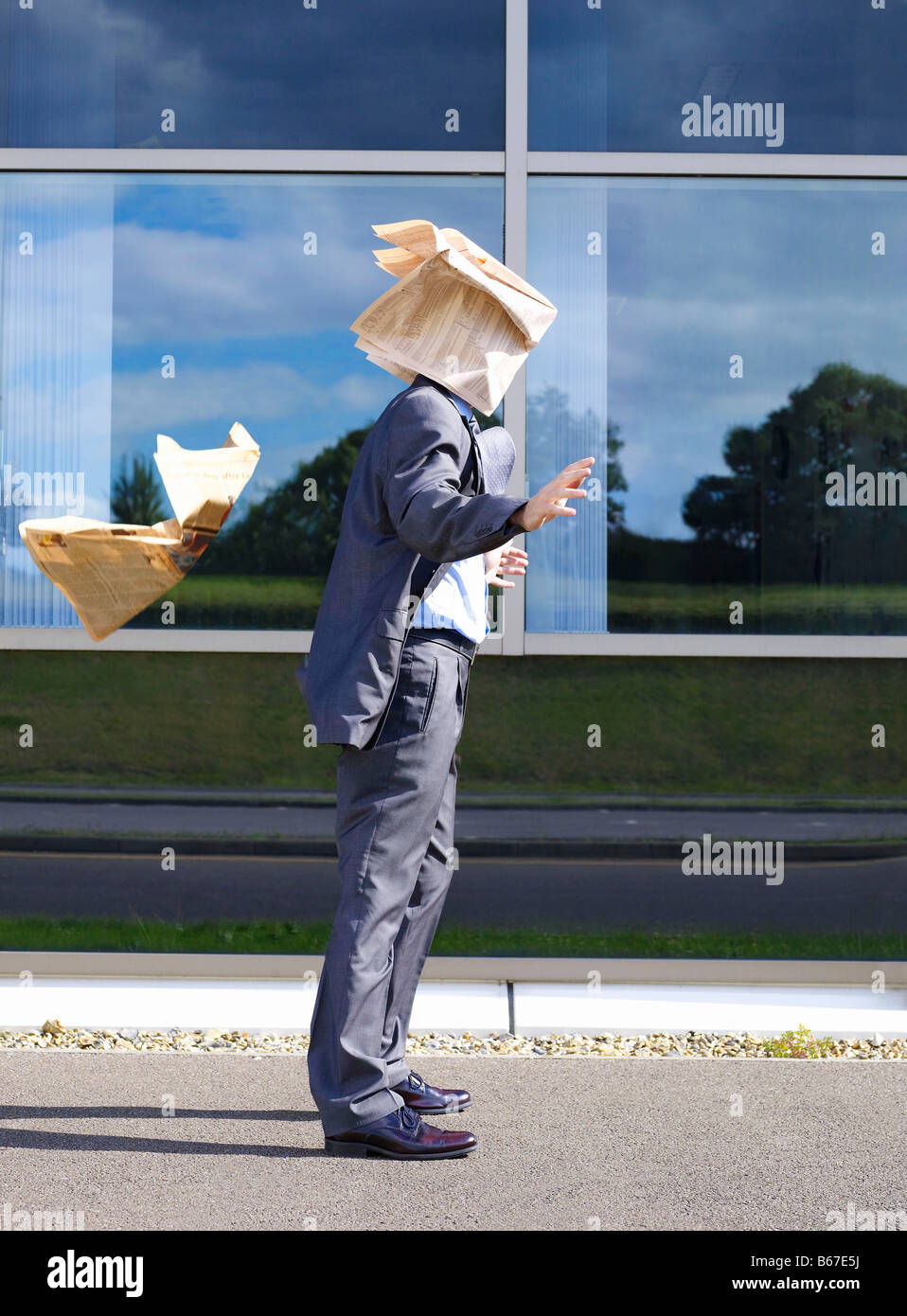 Businessman with newspaper over face Stock Photo - Alamy